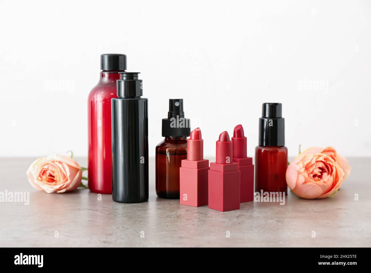 Set of cosmetic products and rose flowers on light background Stock ...