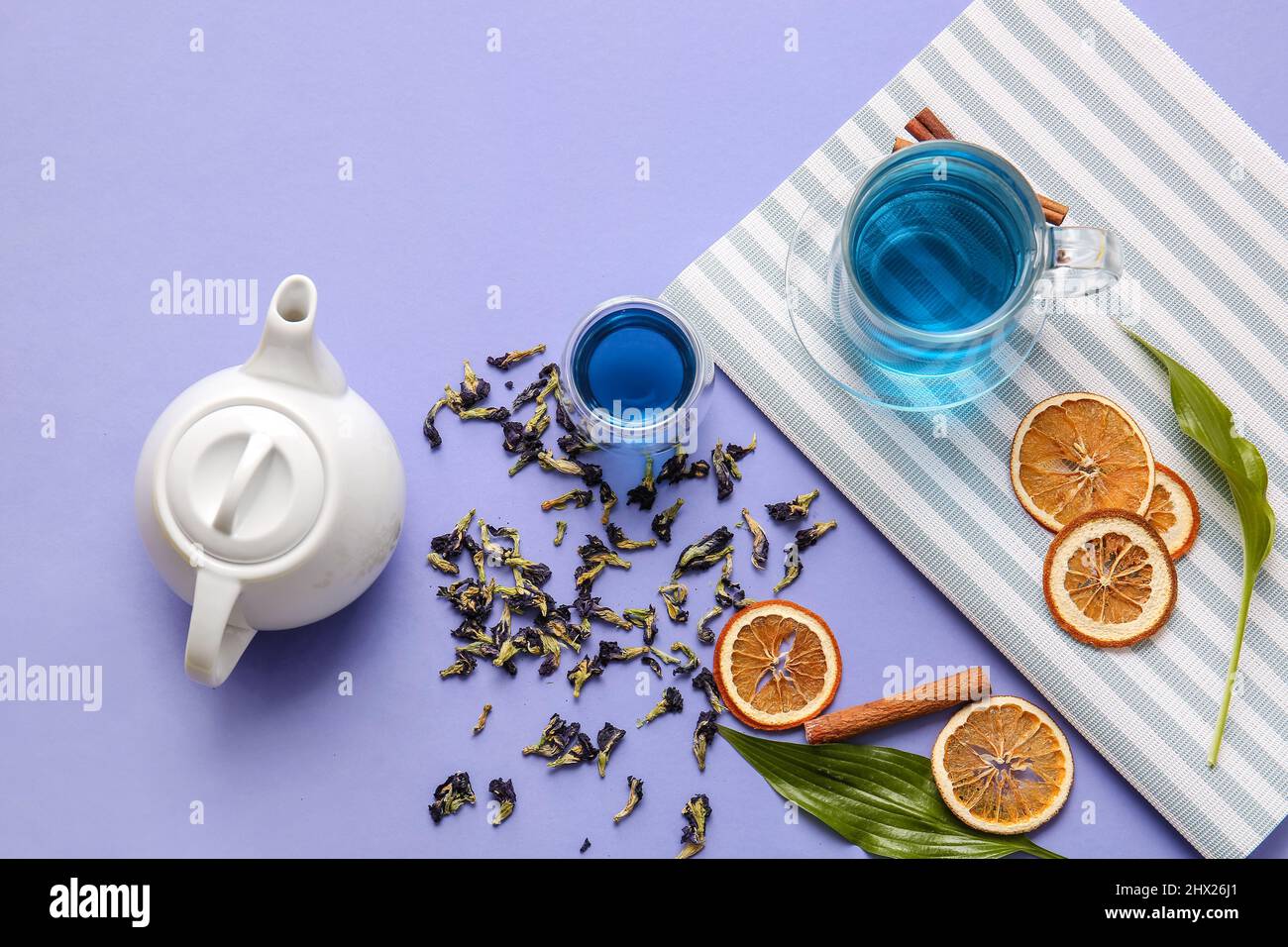 Composition with cups of blue tea, dried fruits and butterfly pea ...