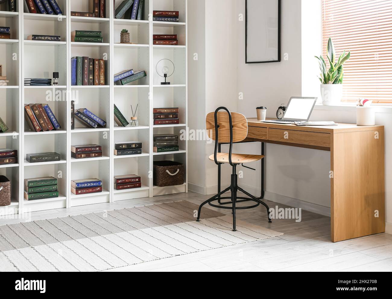 Interior of modern home library with workplace Stock Photo - Alamy