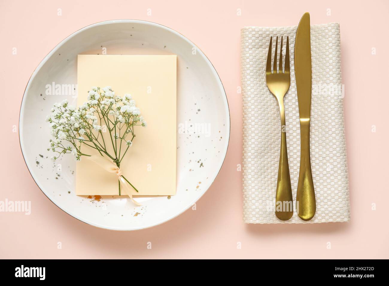 Simple table setting with flowers on beige background Stock Photo - Alamy