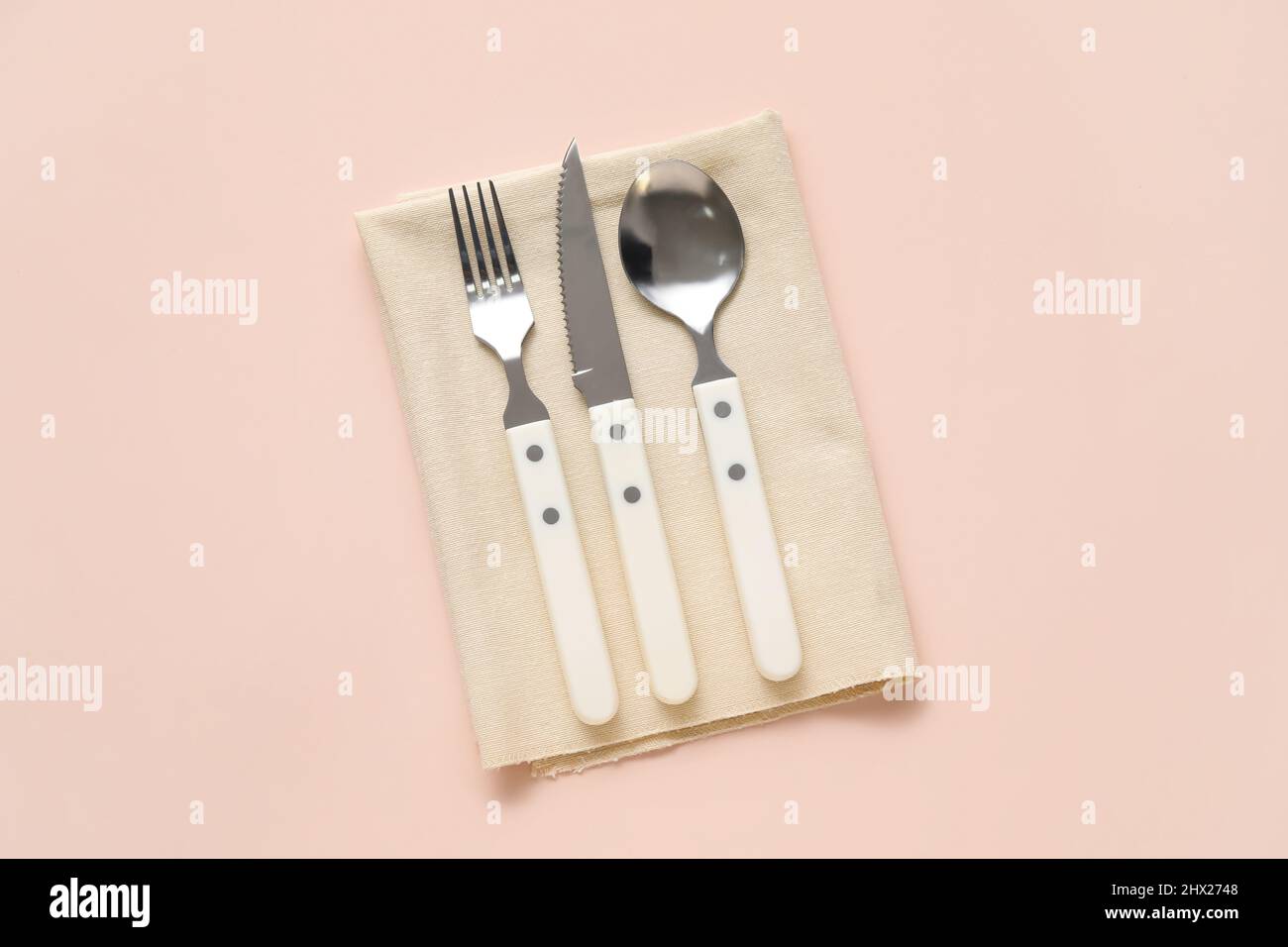Simple table setting on beige background Stock Photo - Alamy