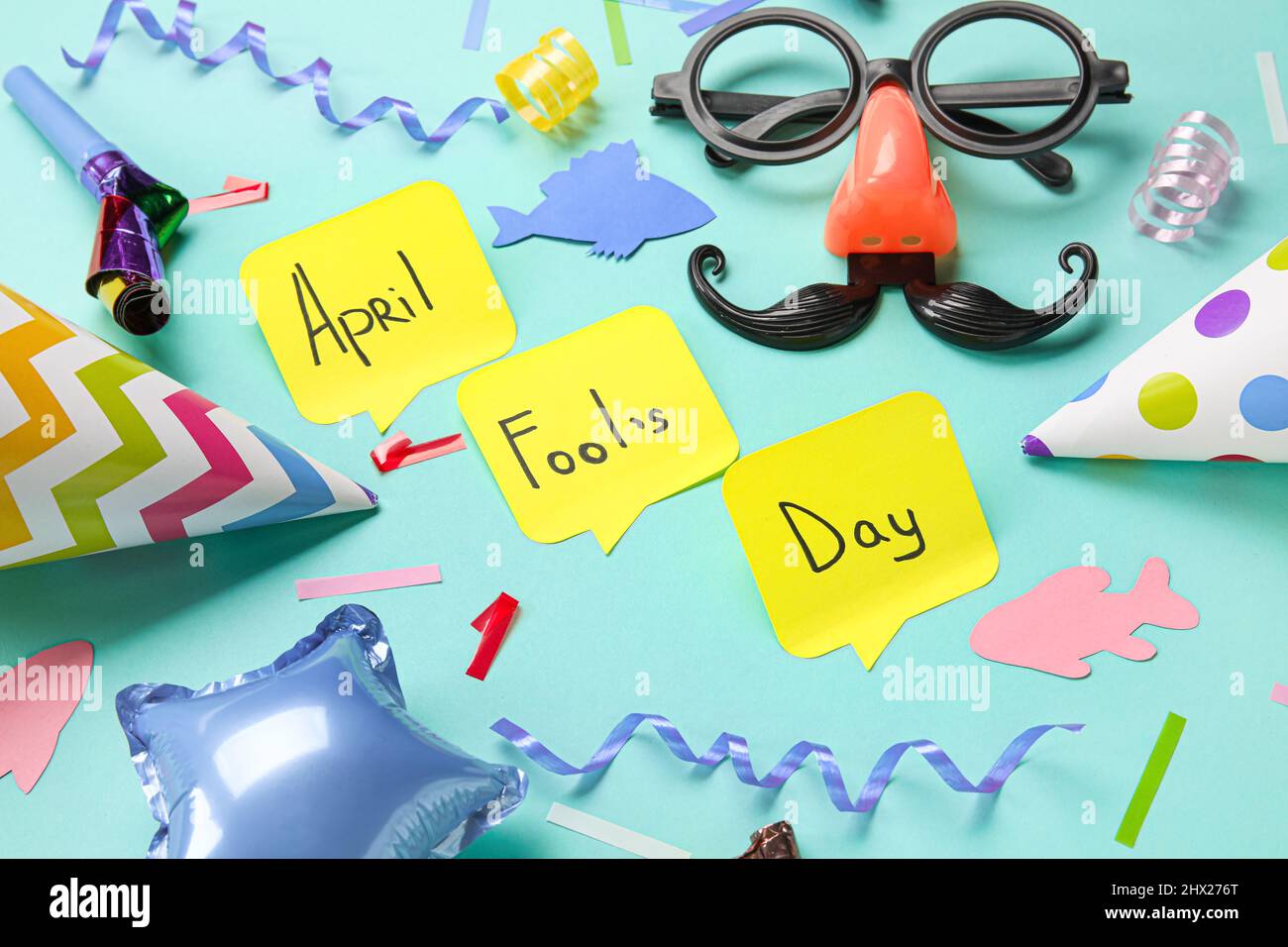 Composition for April Fools Day and party decor on turquoise background ...