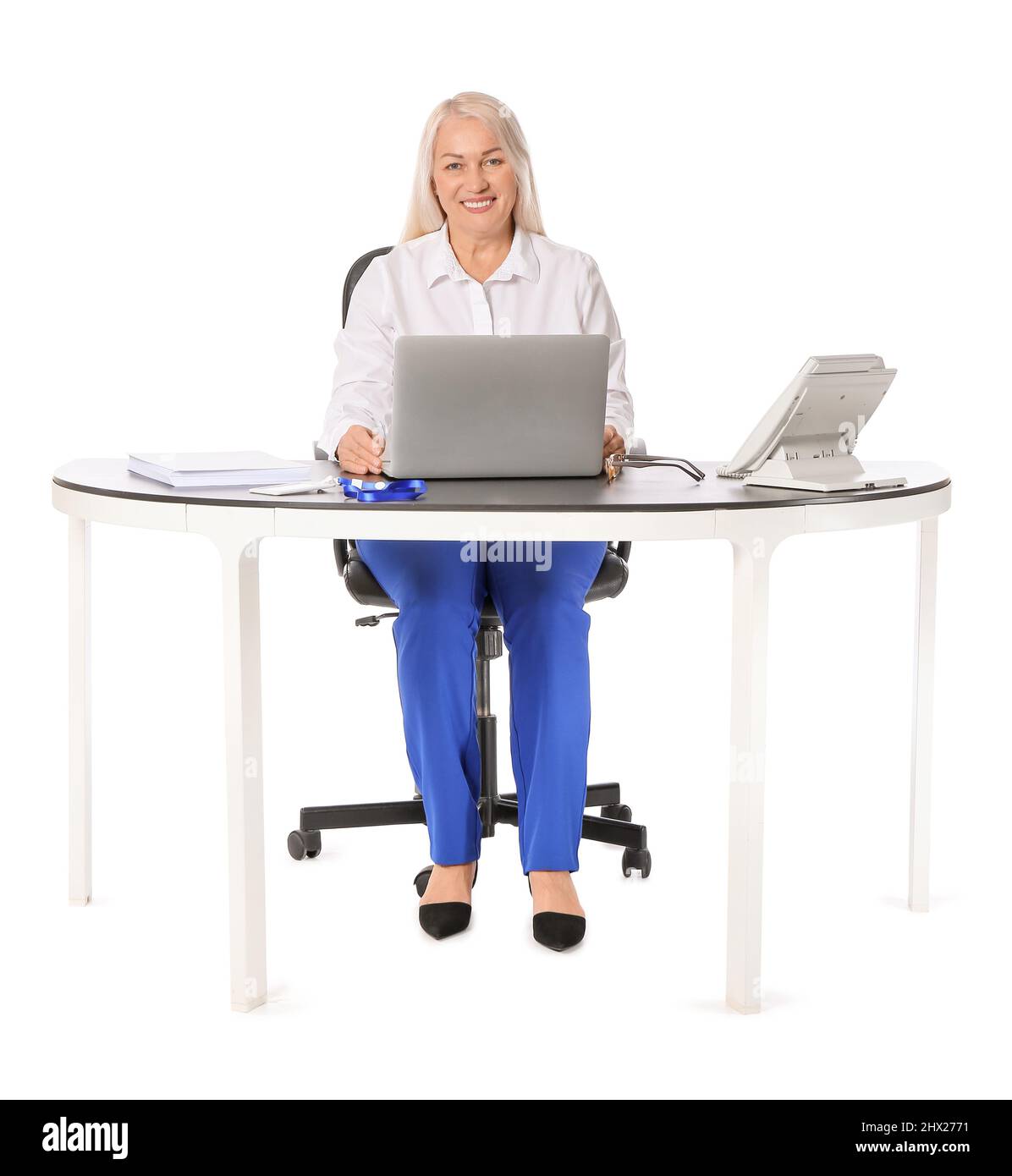 Mature secretary at table on white background Stock Photo - Alamy