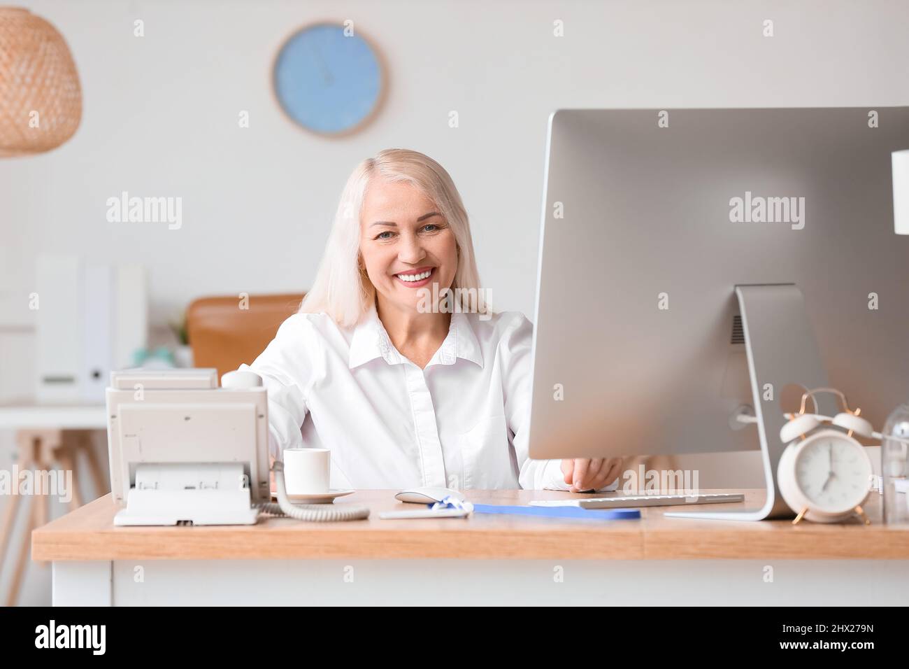Mature secretary working in office Stock Photo - Alamy
