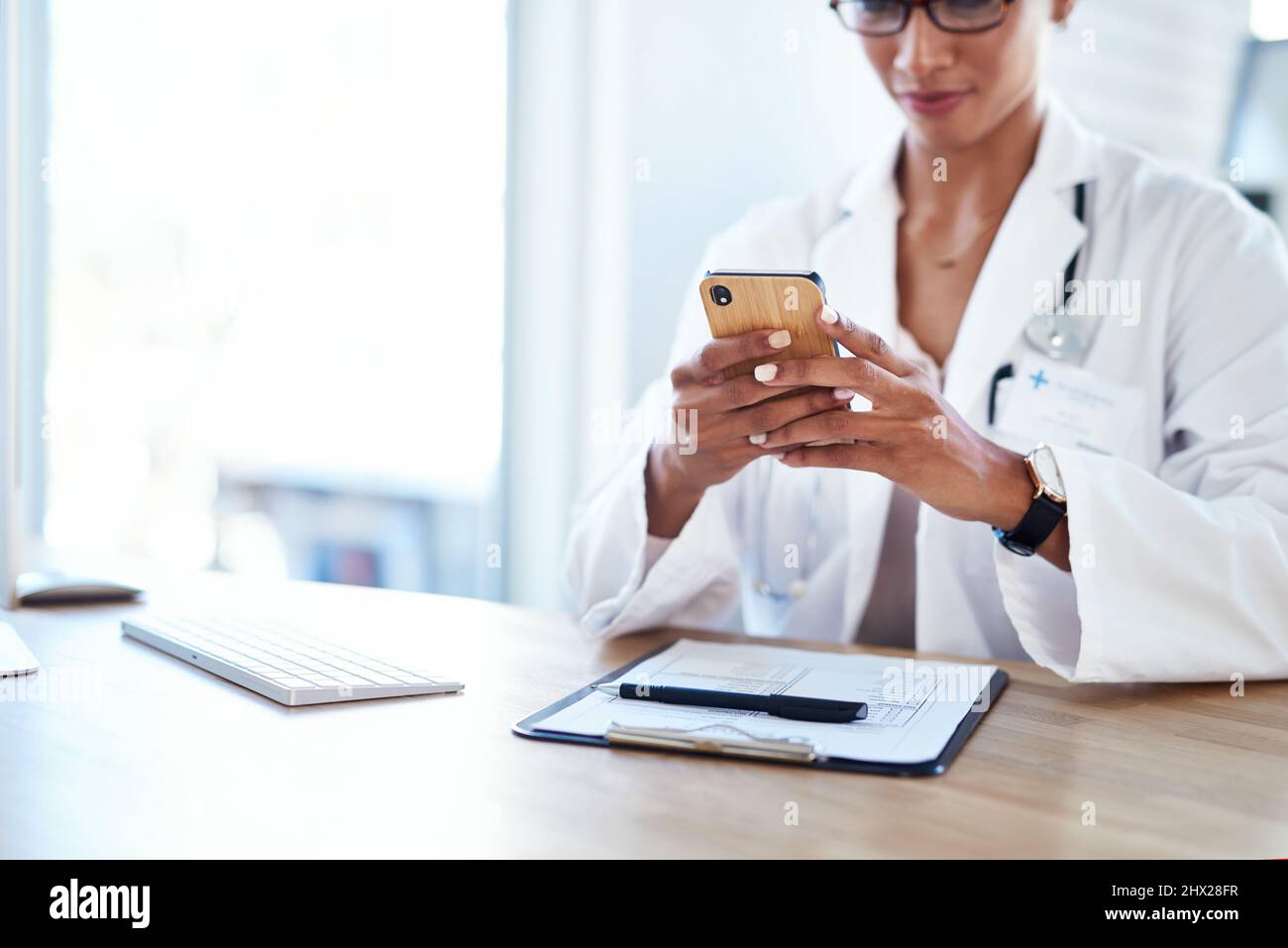 Smart apps for a smart doctor. Shot of a young doctor using a ...
