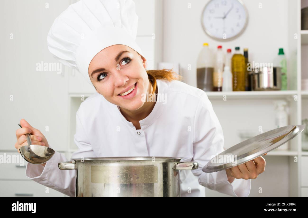 Female cook tasting food Stock Photo - Alamy