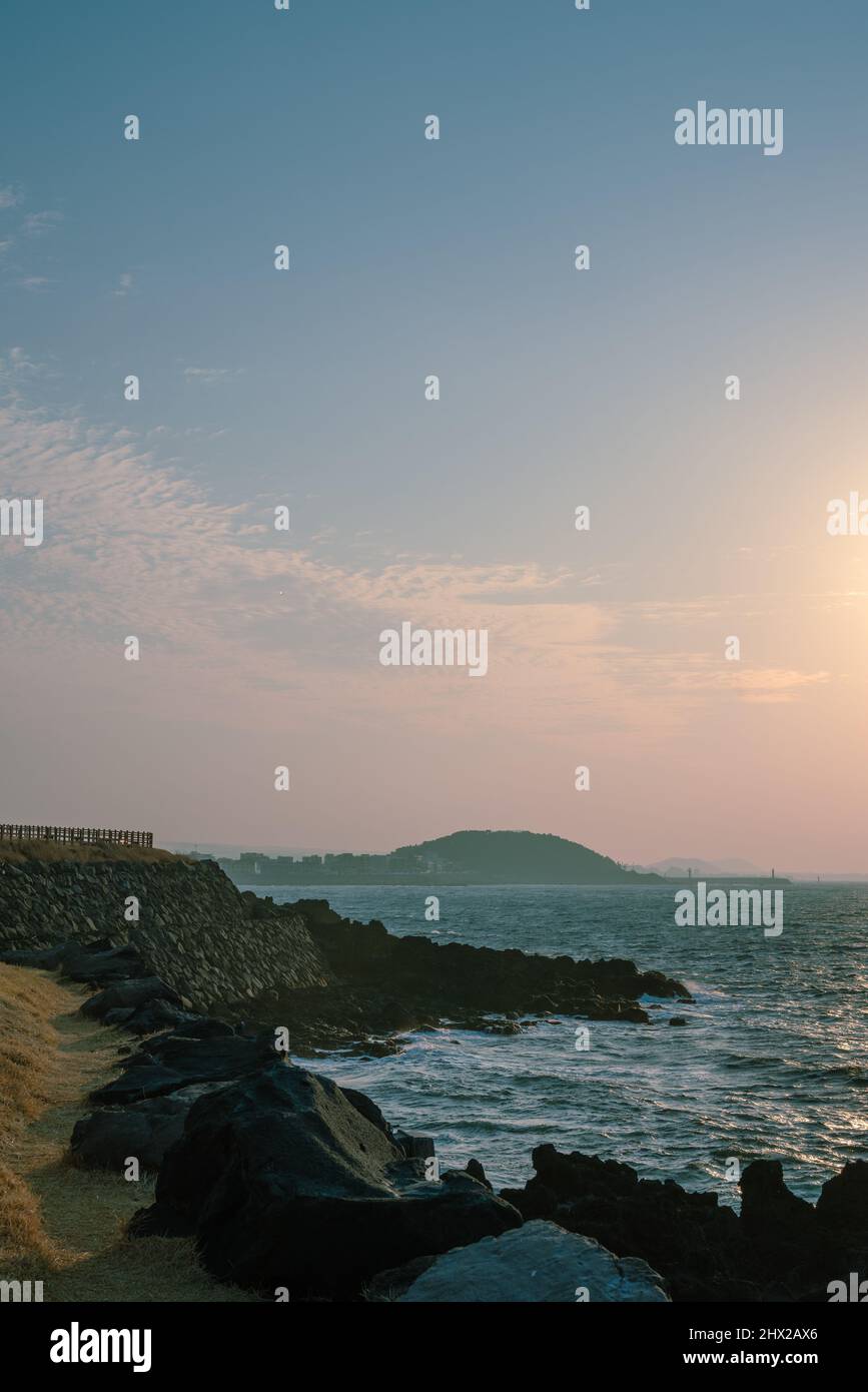 Sunset sea and Dodubong, Jeju Olle Trail route 17 in Jeju Island, Korea ...
