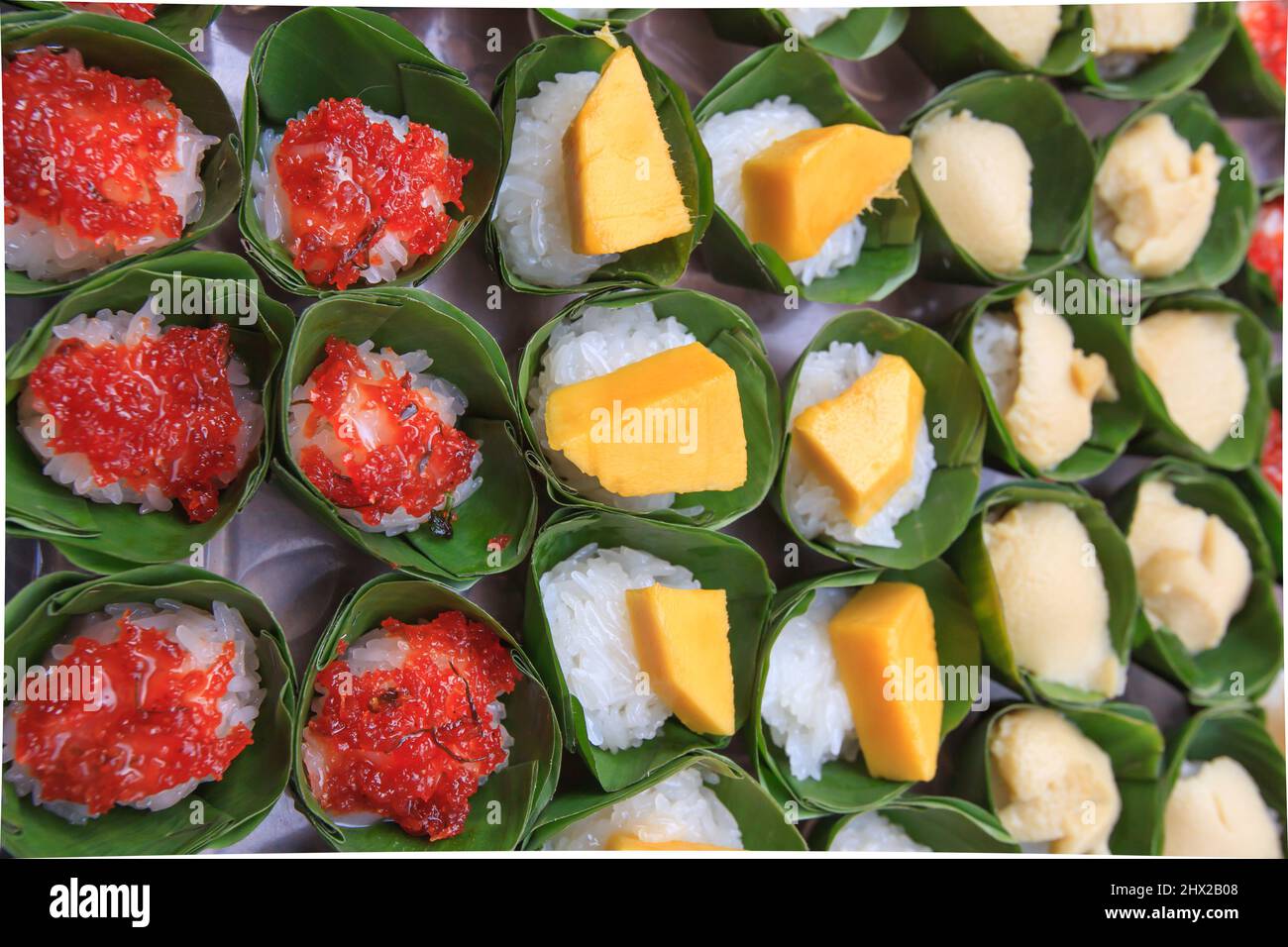 Sweet ripe mango and sticky rice in coconut milk in banana leaves, Thai ...