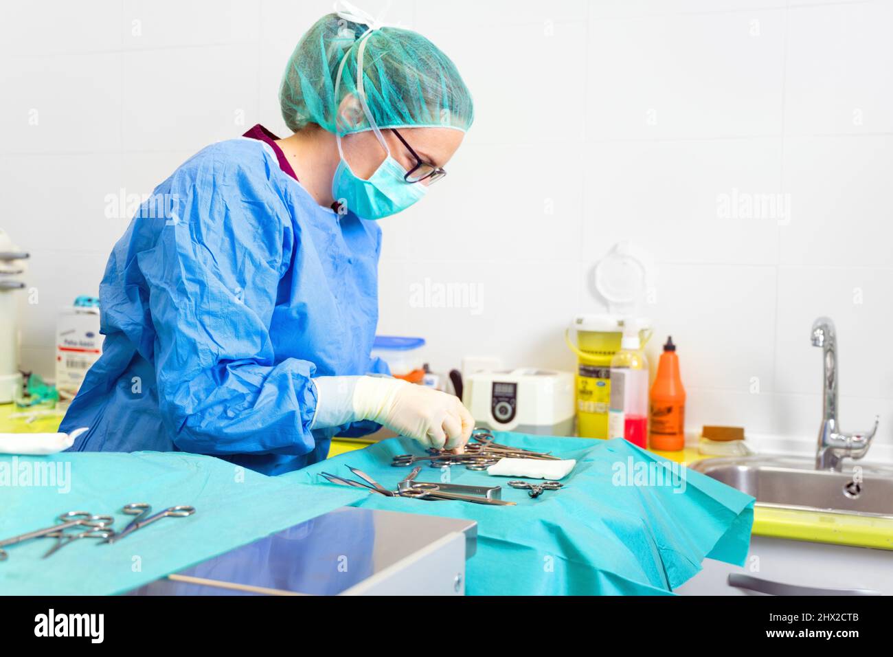 Female nurse preparing operation theatre for surgery. High quality ...