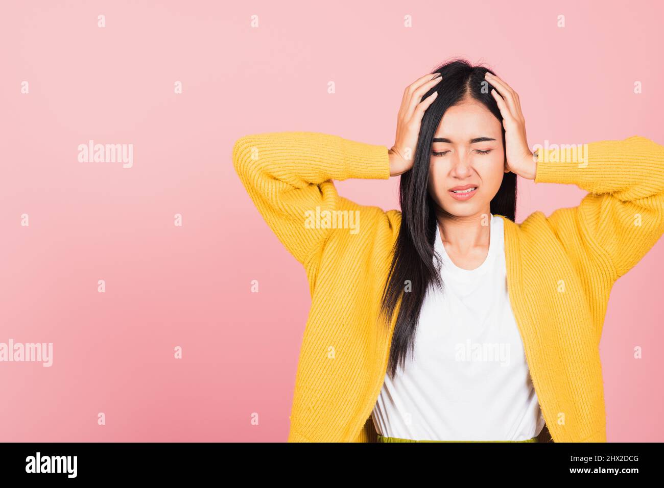 Portrait of beautiful Asian young woman sad tired strain face holding ...