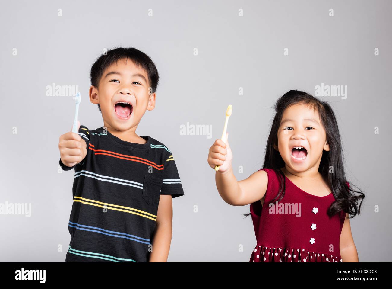 Little cute kid boy and girl 3-6 years old show brush teeth and smile ...