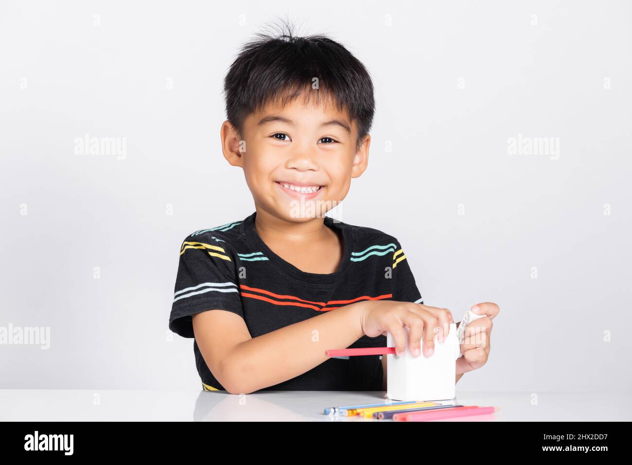 Boy sharpening pencil hi-res stock photography and images - Alamy