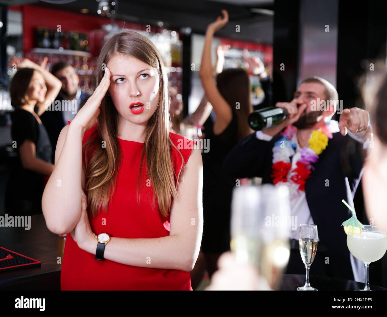 Offended woman with drunk man on party at nightclub Stock Photo - Alamy