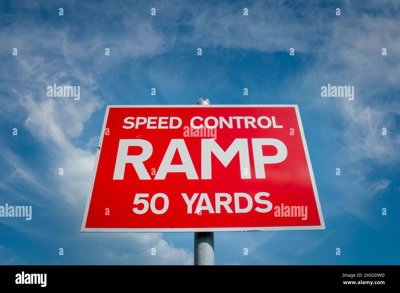 Street sign, speed control ramp sign. Red against a blue sky Stock ...
