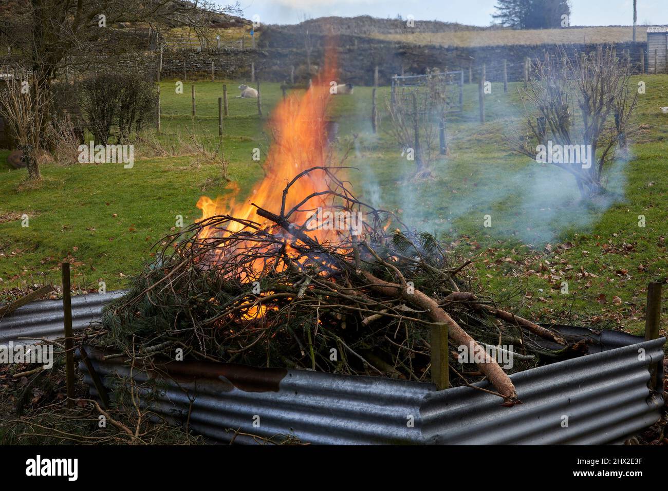 Bonfire clearing up after storm damage rubbish Stock Photo - Alamy