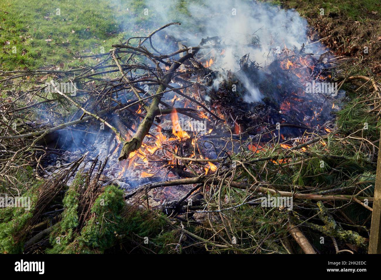 Bonfire clearing up after storm damage rubbish Stock Photo - Alamy