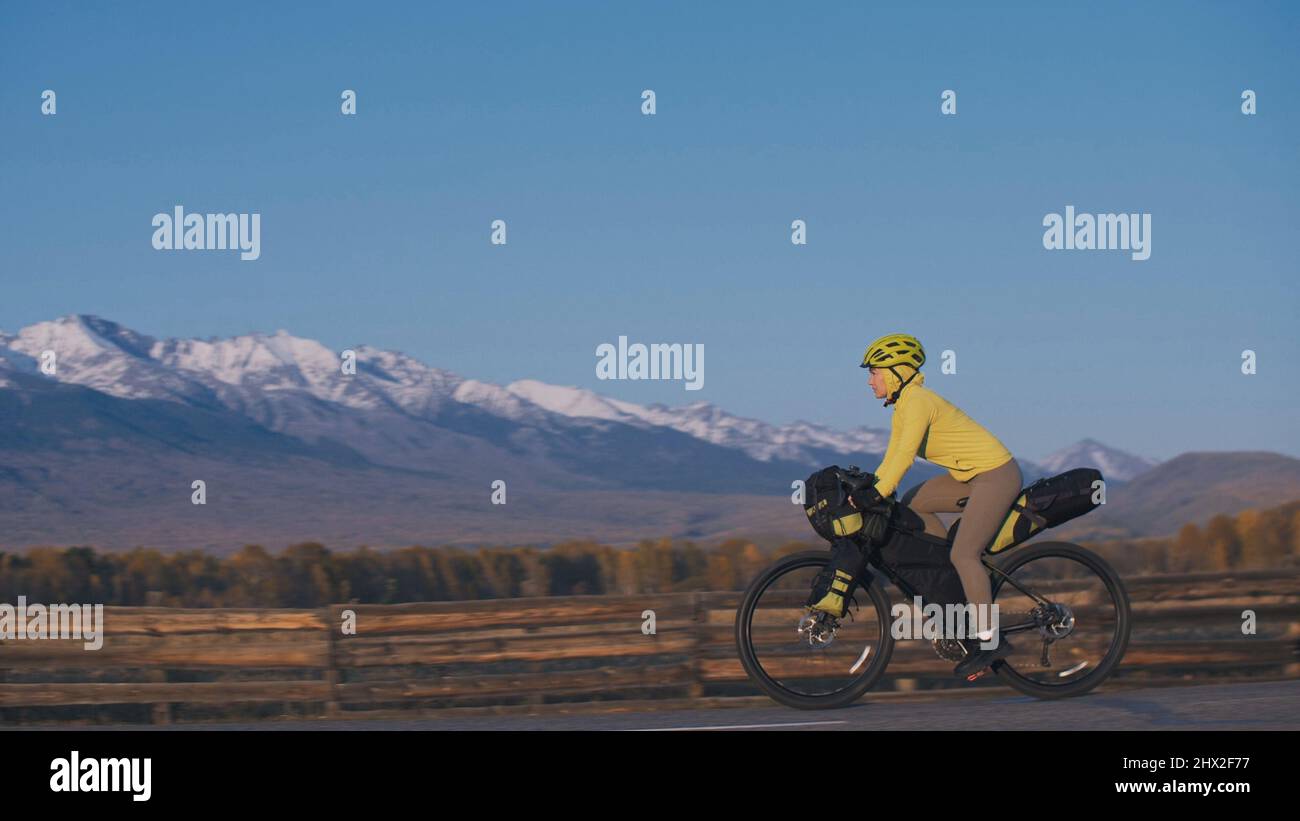 The woman travel on mixed terrain cycle touring with bikepacking. The ...