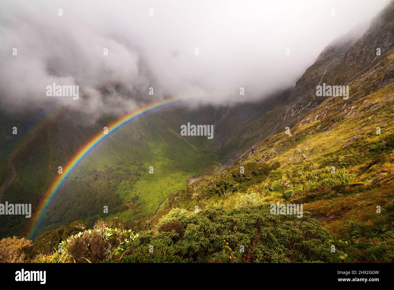 Rainbow over the valley between Mintaro Hutt and Mackinnon Pass ...