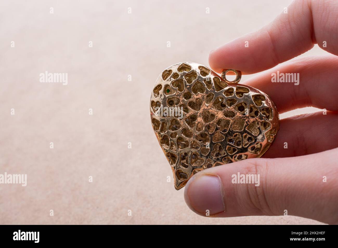 Heart shaped metal object in hand Stock Photo - Alamy