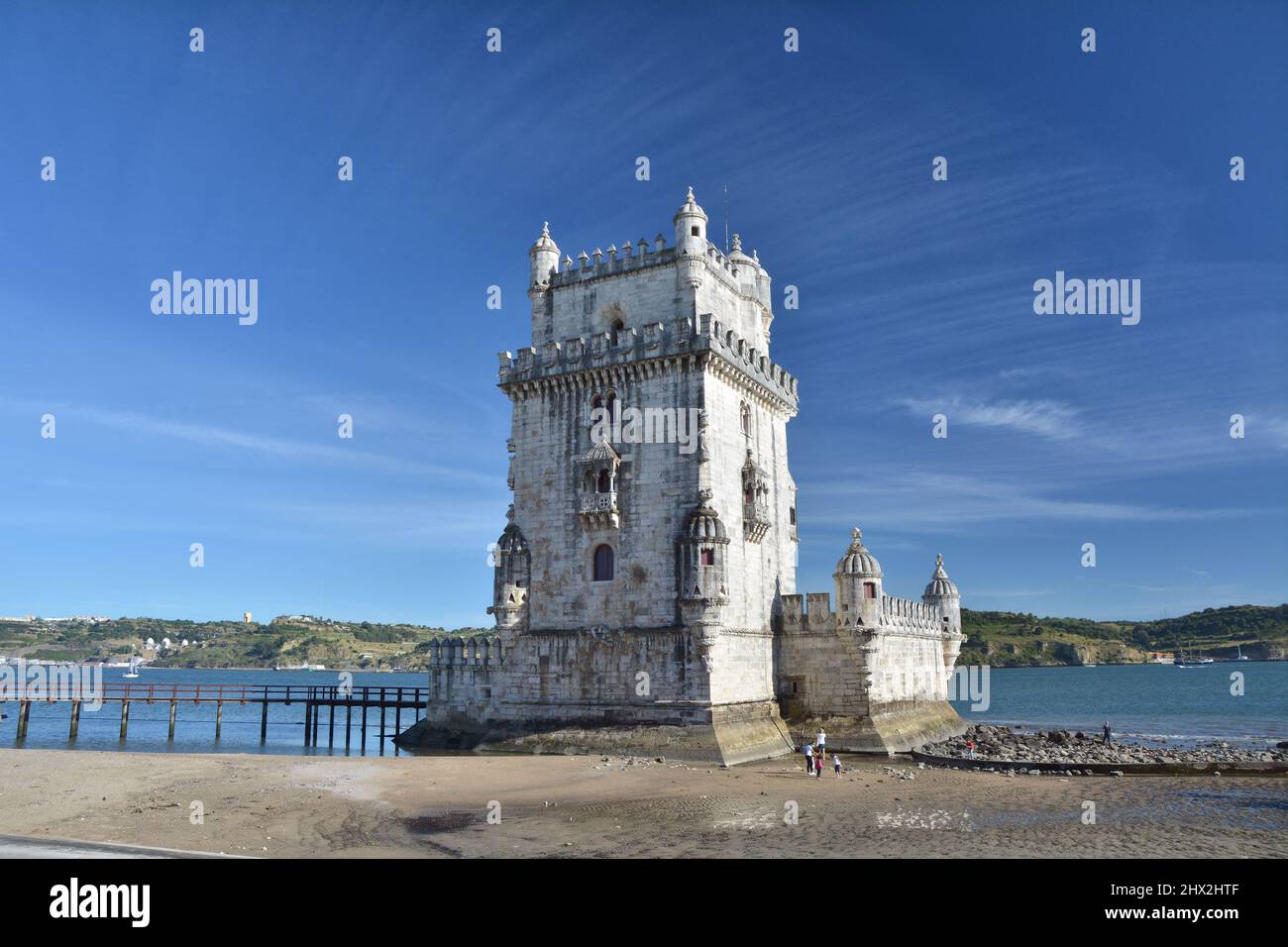 Belem tower in Lisbon, Portugal during low tide. Torre de Belem is ...