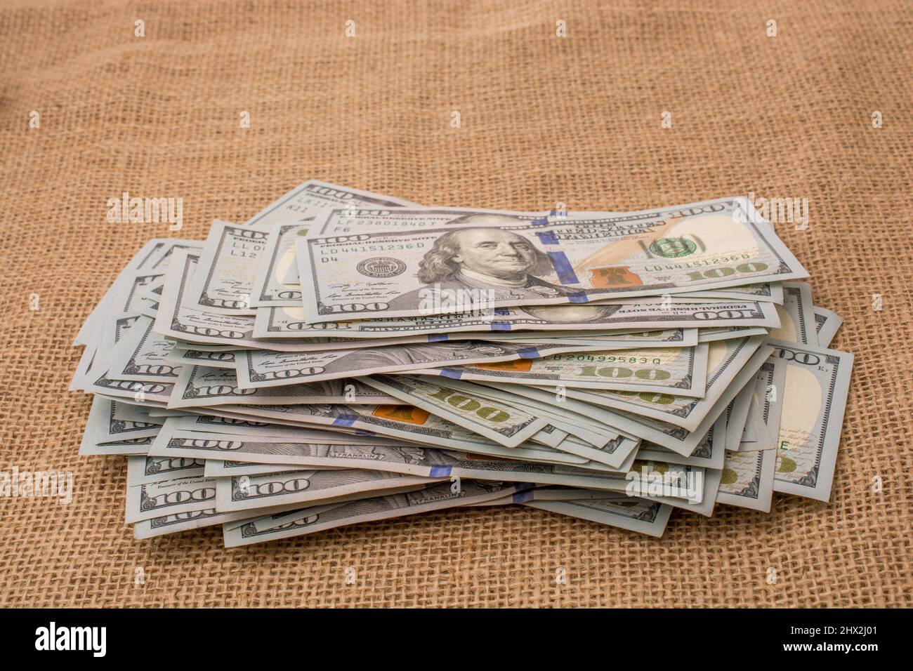 Banknote bundle of US dollar placed on a linen canvas Stock Photo - Alamy