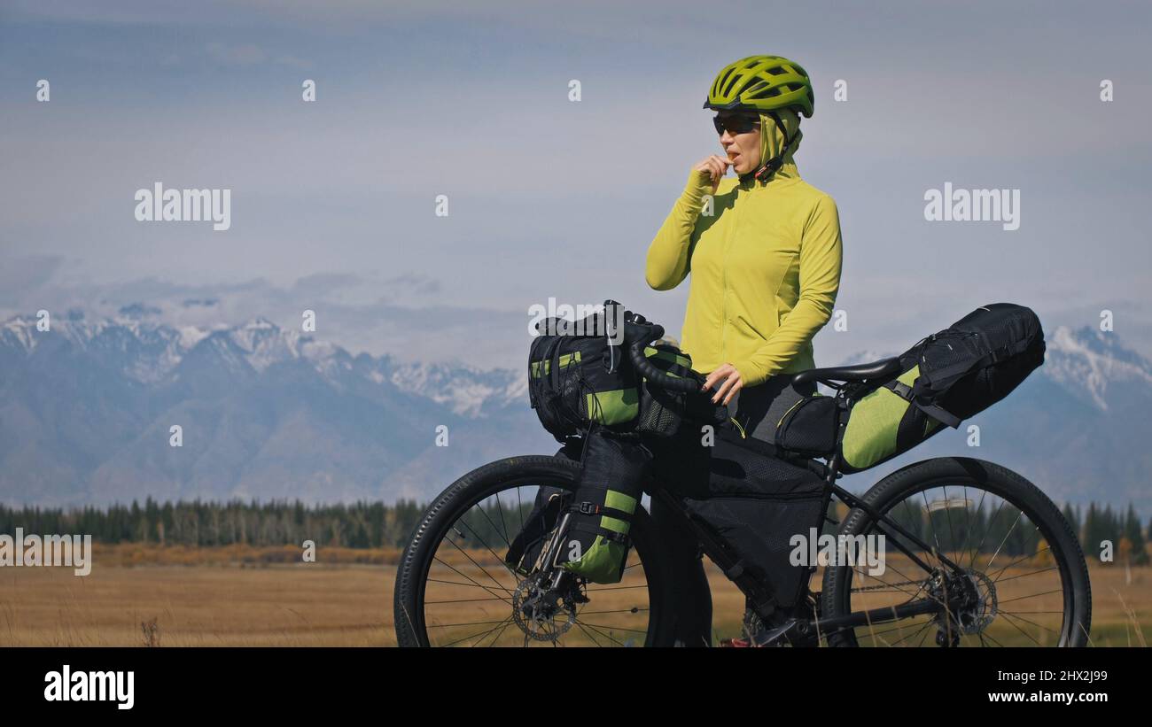 The woman travel on mixed terrain cycle touring with bikepacking. The ...