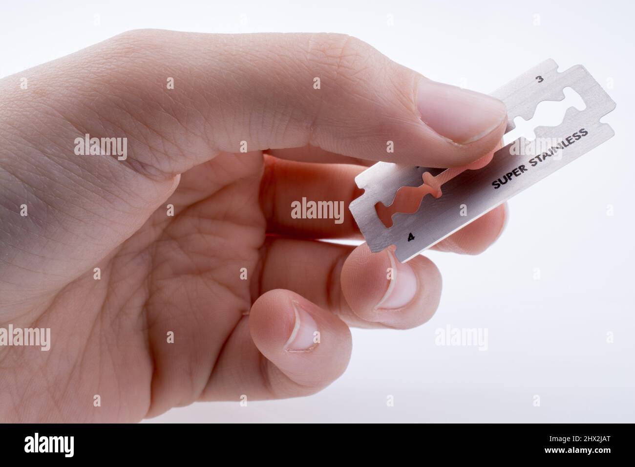 Hand holding sharp razor blade hi-res stock photography and images - Alamy