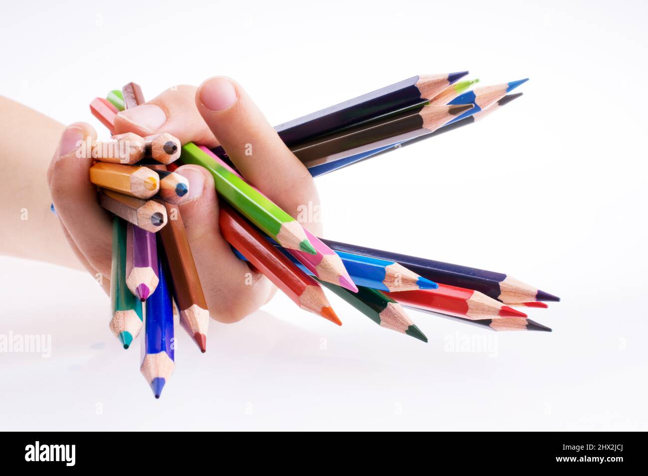 Hand holding color pencils on a white background Stock Photo - Alamy