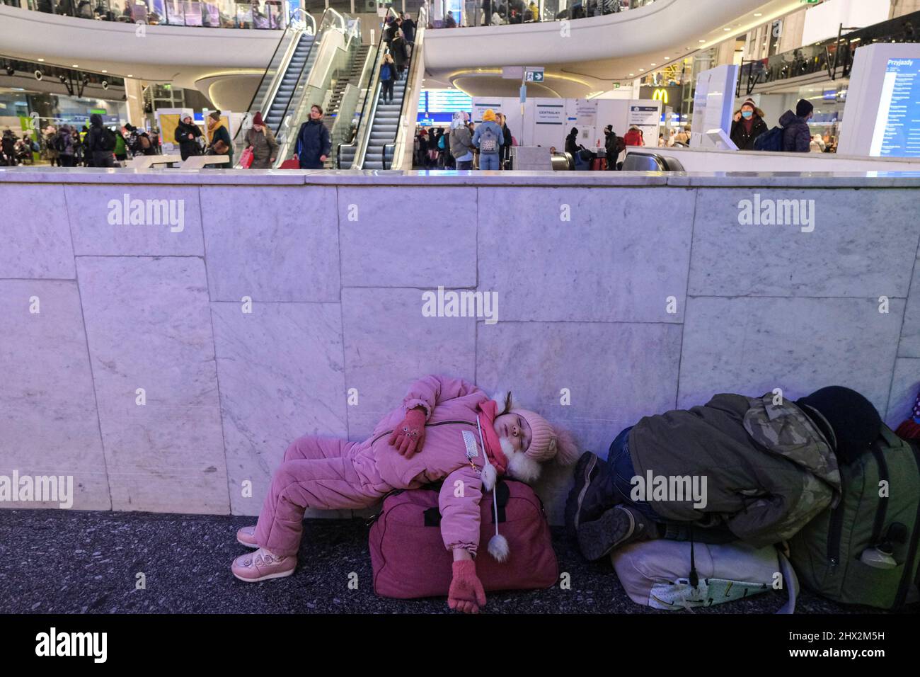Two Children Seen Sleeping On Their Luggage At Warszawa Centralna