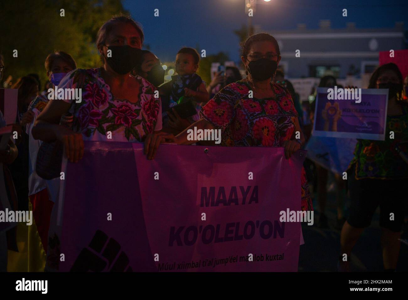 Non Exclusive: MERIDA, MEXICO - MARCH 8, 2022: Two women hold a banner ...