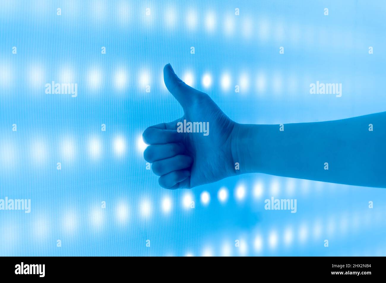 hand and led touch screen blue light science and technology background ...