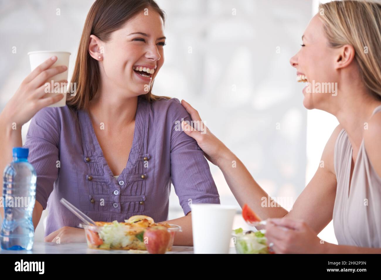 Lunch break bonding. Shot of two colleagues having lunch together Stock ...