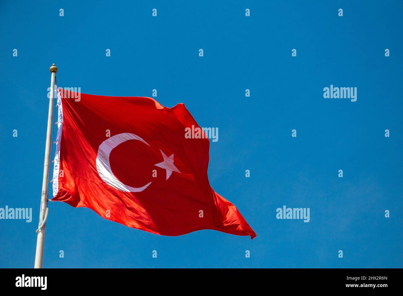 Turkish national flag with white star and moon in sky Stock Photo - Alamy