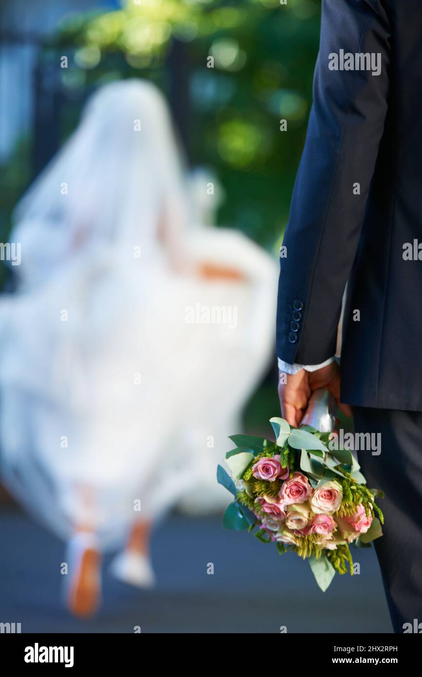 Runaway bride. Cropped shot of a disheartened groom as his bride runs ...