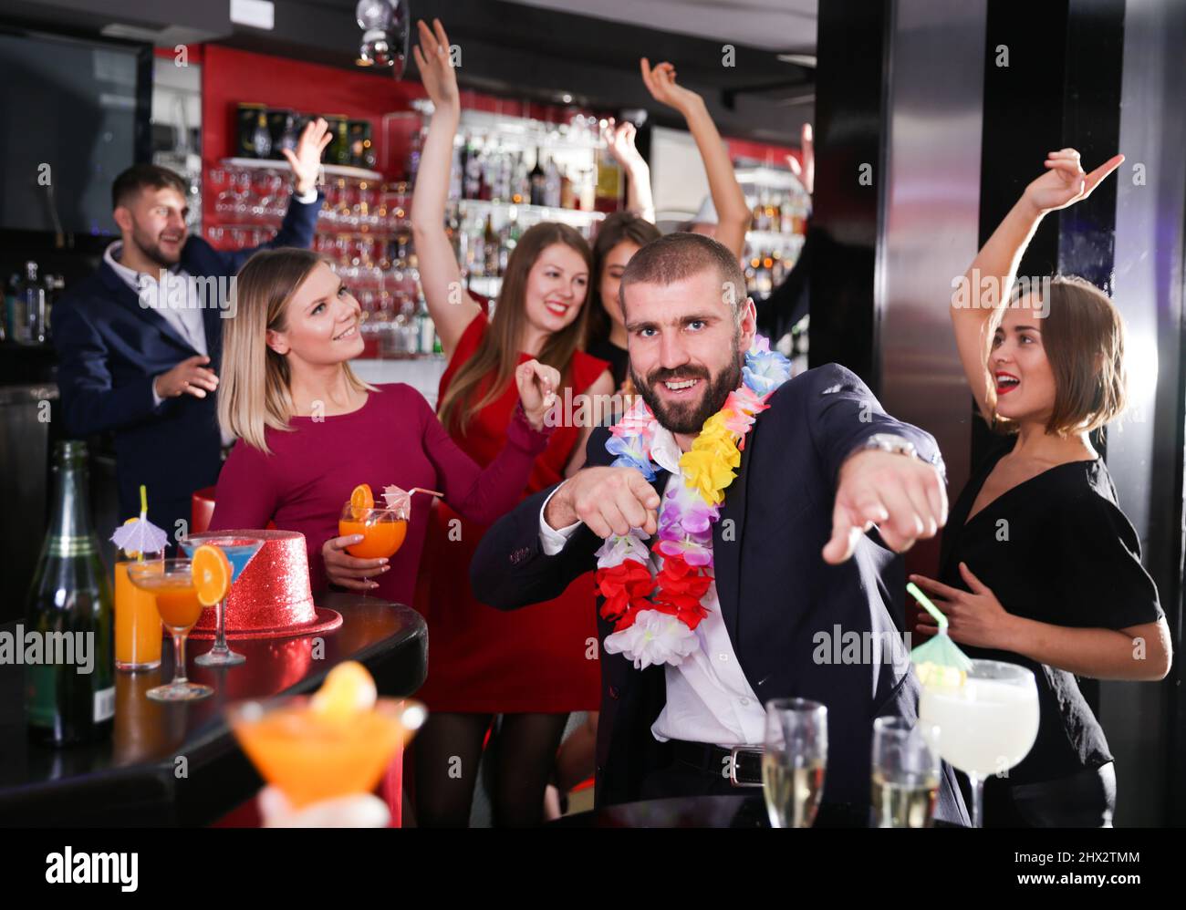 Man having fun on Hawaiian party at nightclub Stock Photo - Alamy