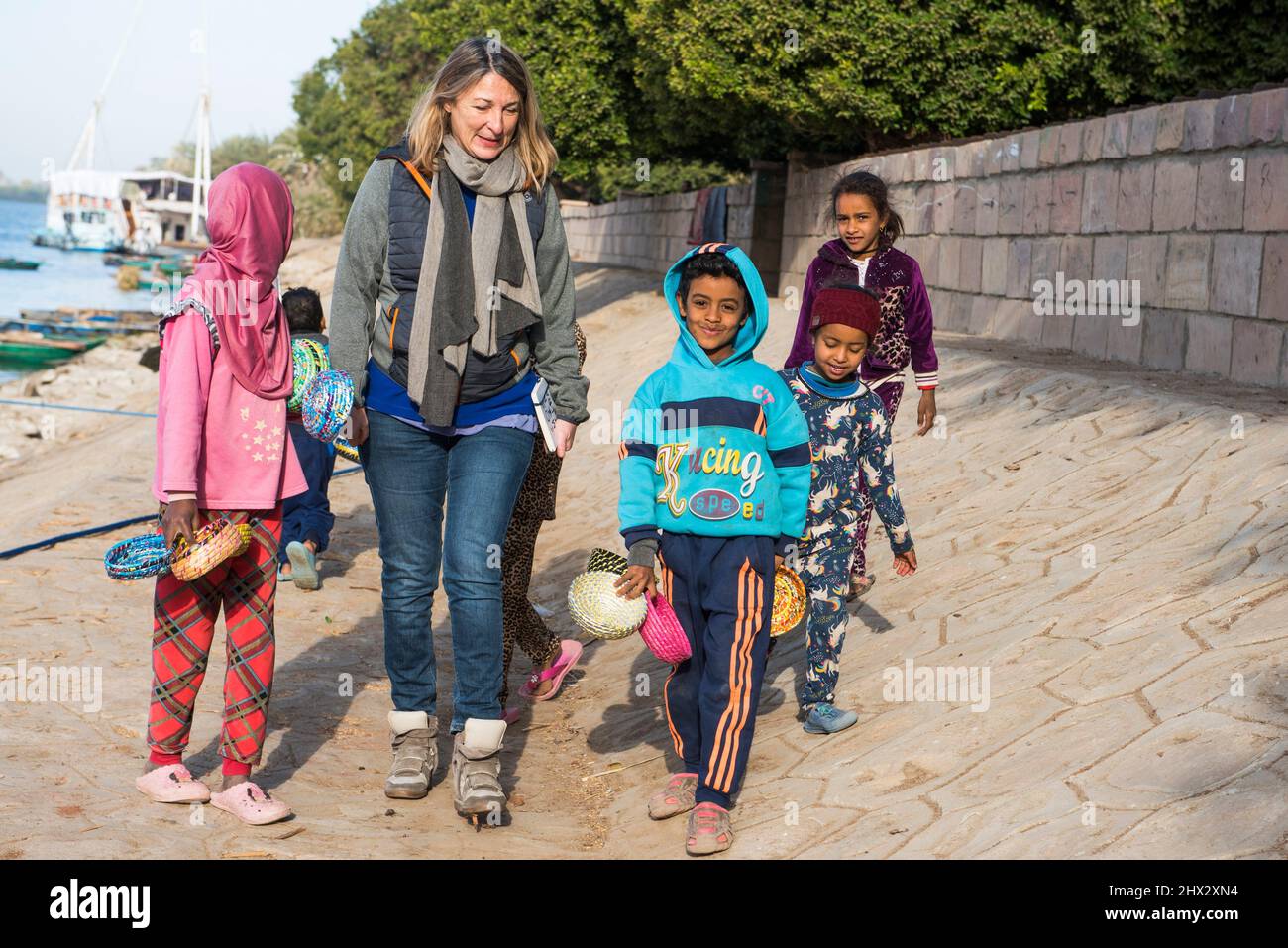 Kids offering souvenirs to visitors, Village on the Nile near the ...