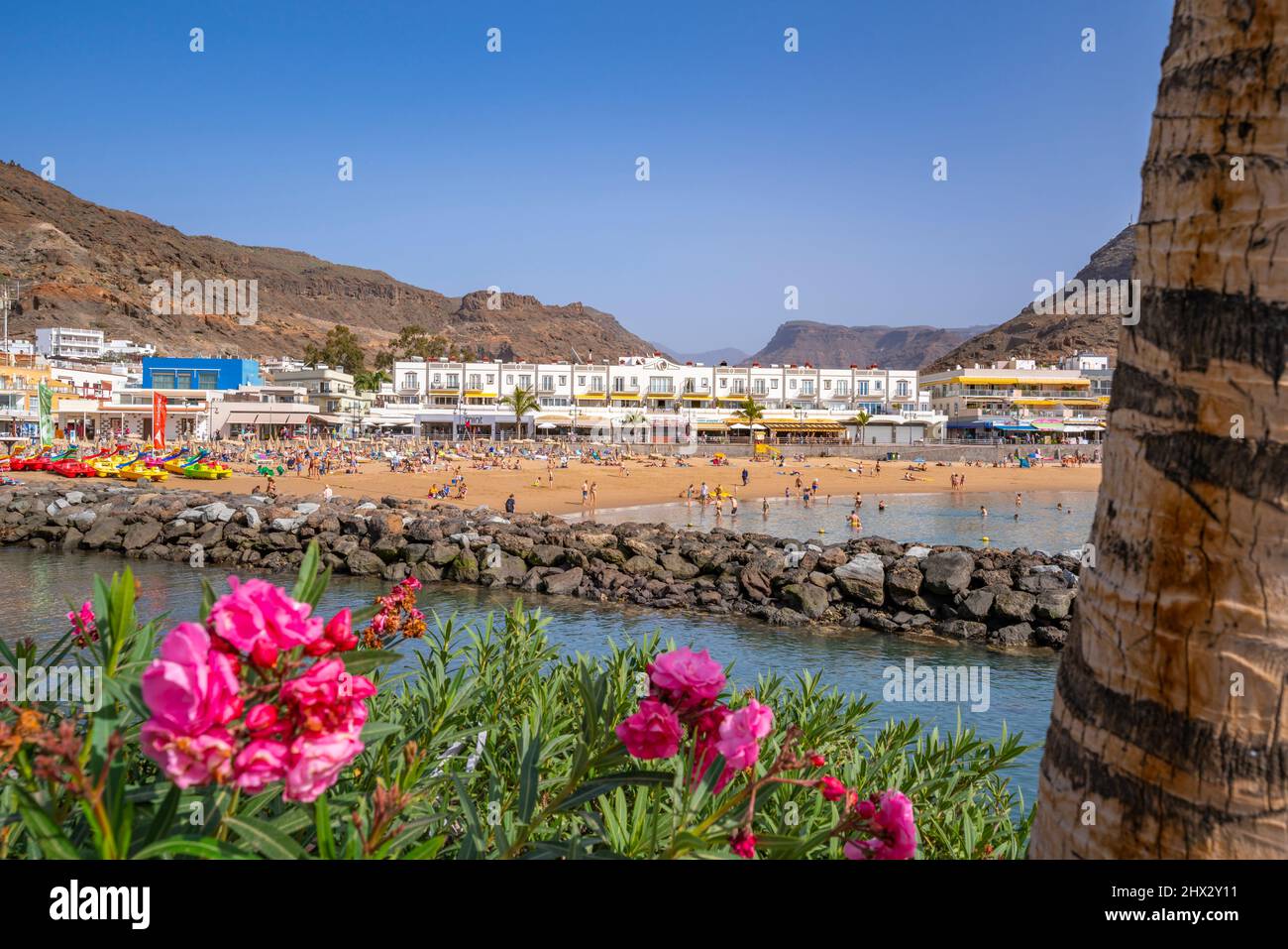 View of beach and colourful buildings along the promenade in the old ...