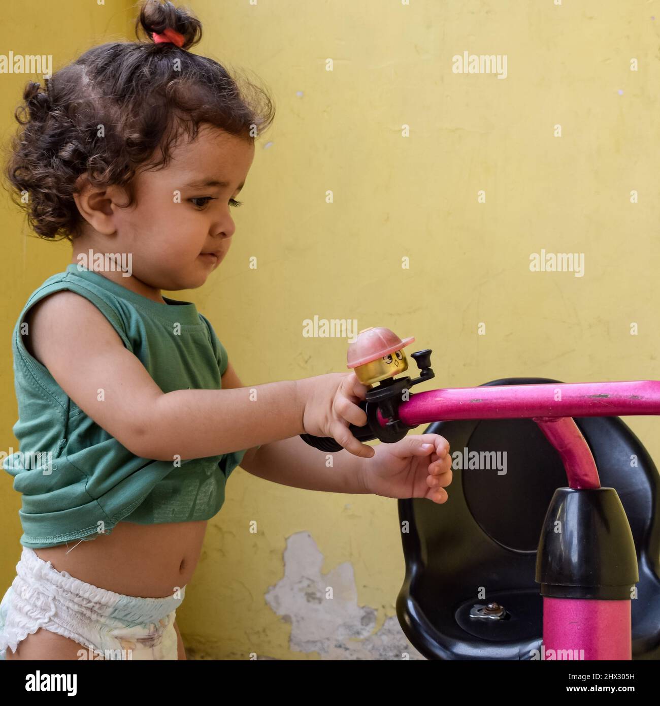 Cute little boy Shivaay driving cycle at home balcony during summer ...
