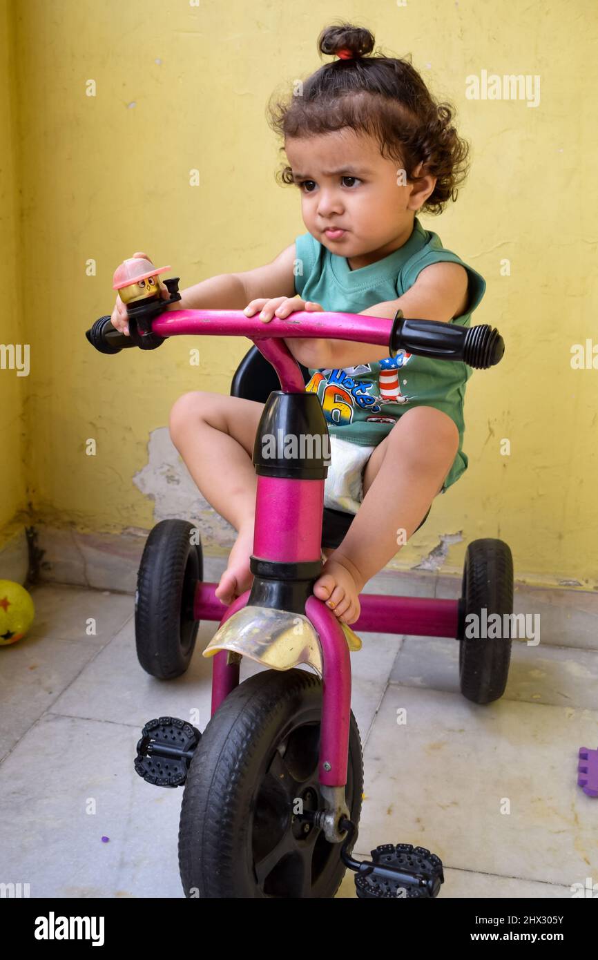 Cute little boy Shivaay driving cycle at home balcony during summer ...