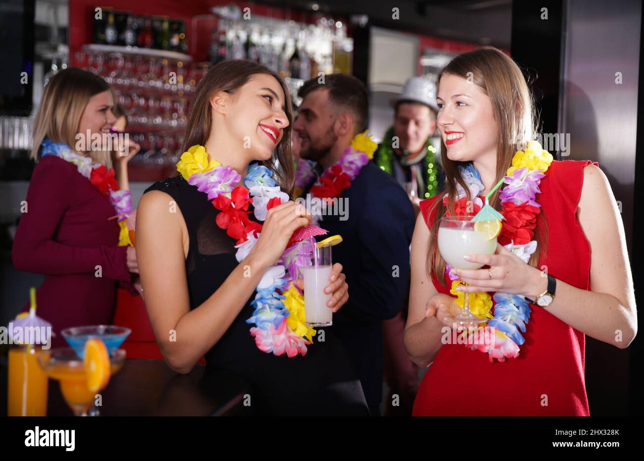 Female colleagues on company party in Hawaiian style in bar Stock Photo ...