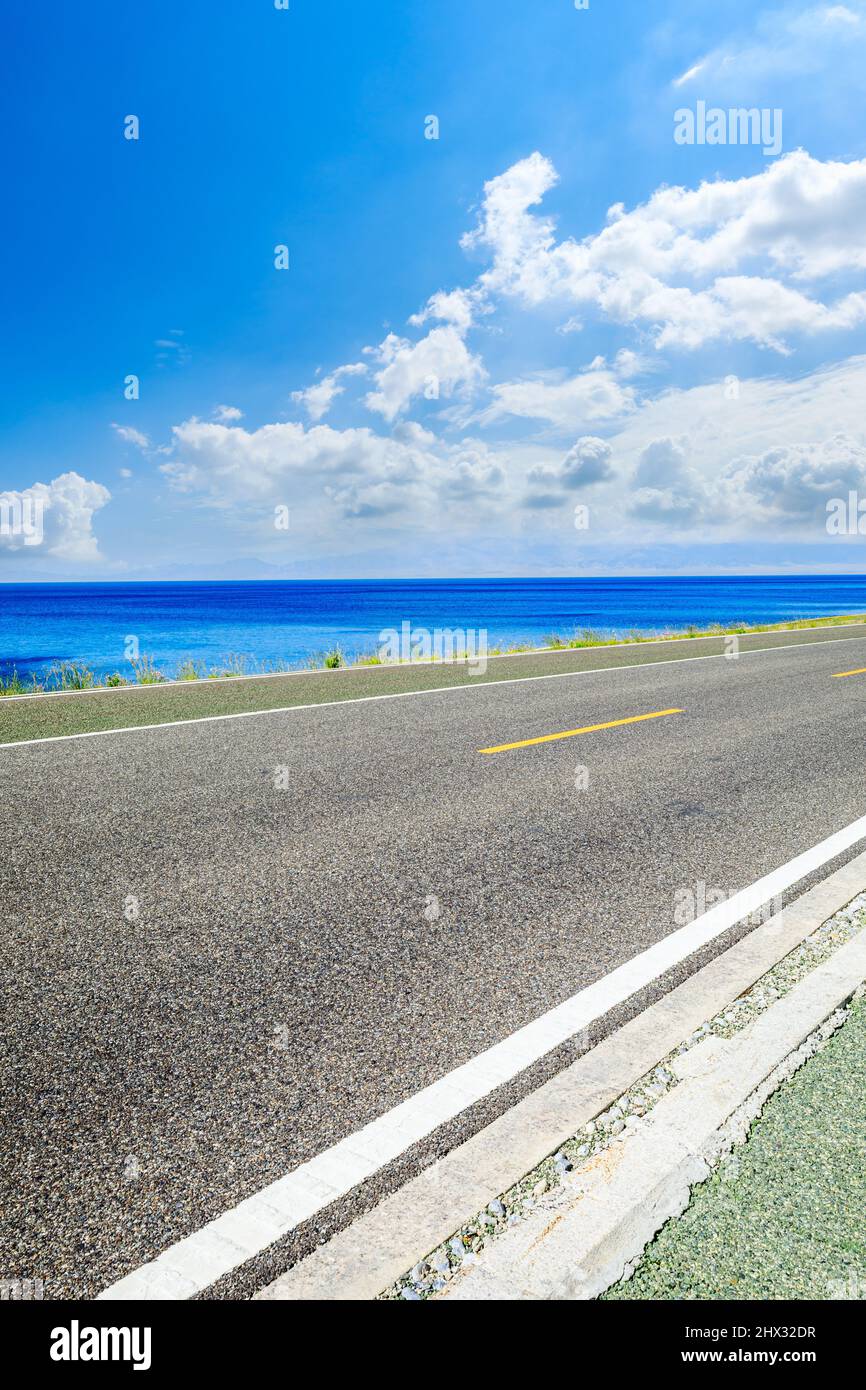 Empty asphalt highway and azure ocean nature scenery under blue sky ...