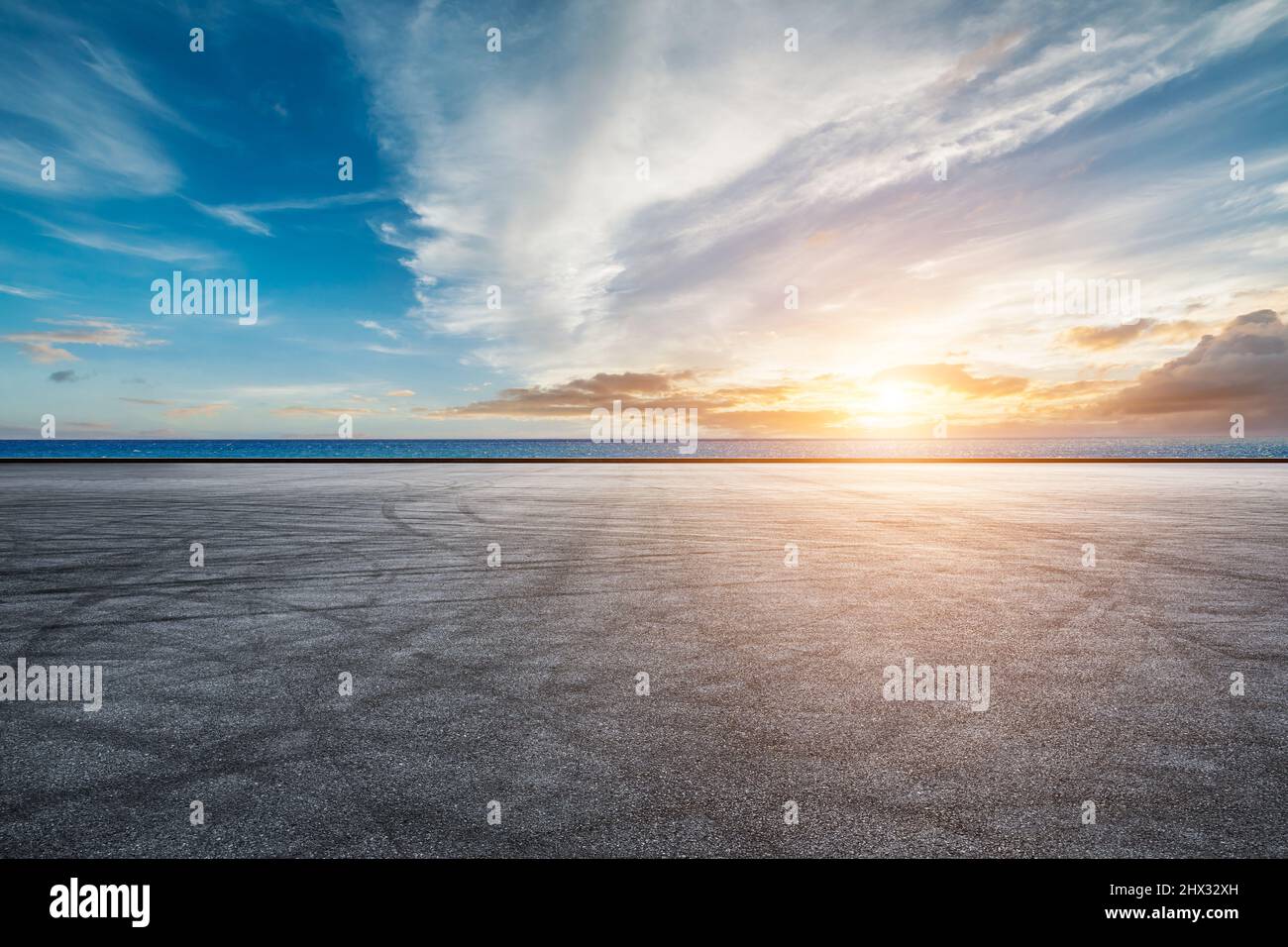 Empty asphalt road and sea natural scenery at sunrise Stock Photo - Alamy Empty asphalt road and sea natural scenery at sunrise Stock Photo - Alamy