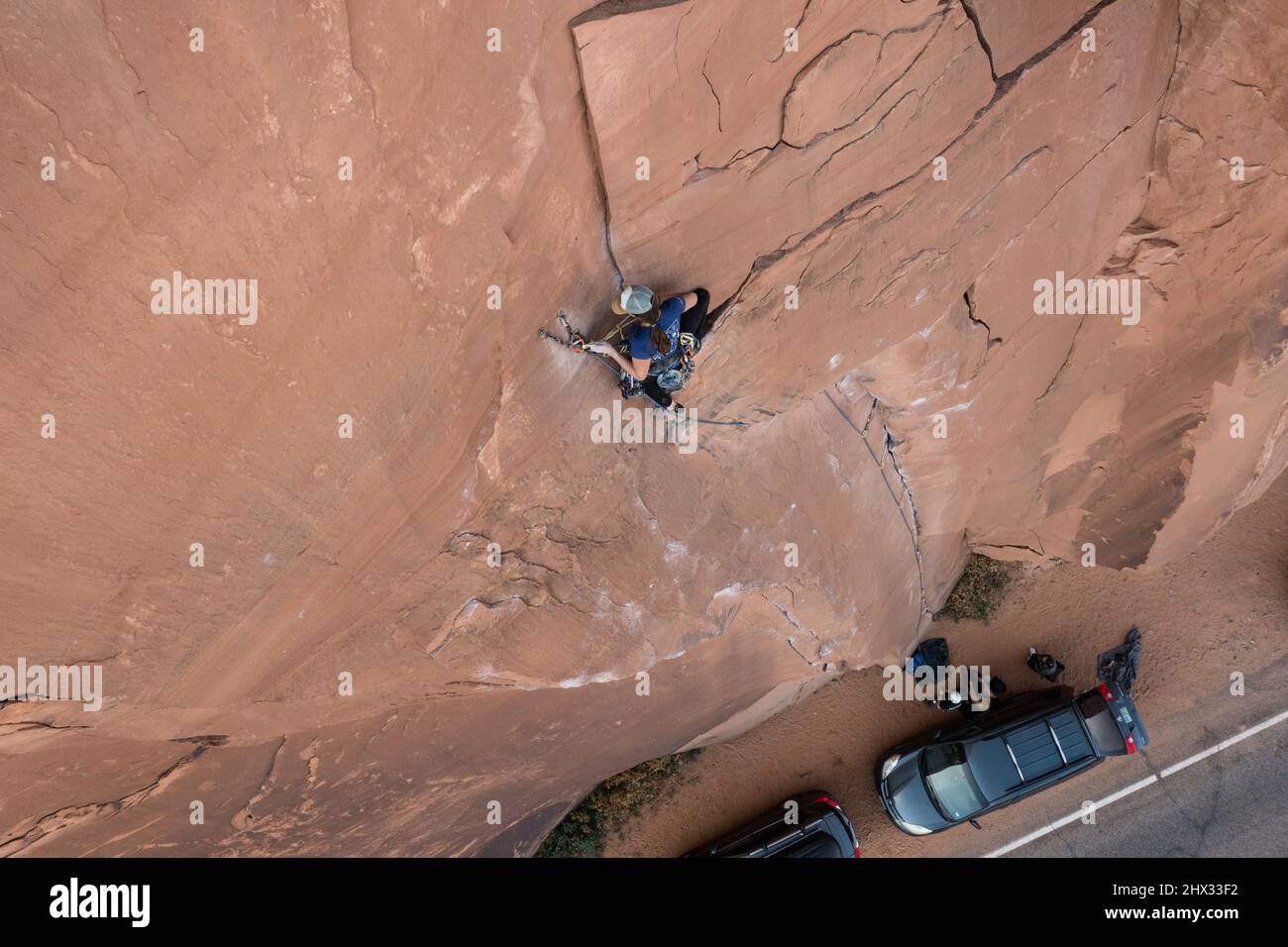 A female lead climber sets up a rope anchor at the top of the Flakes of ...