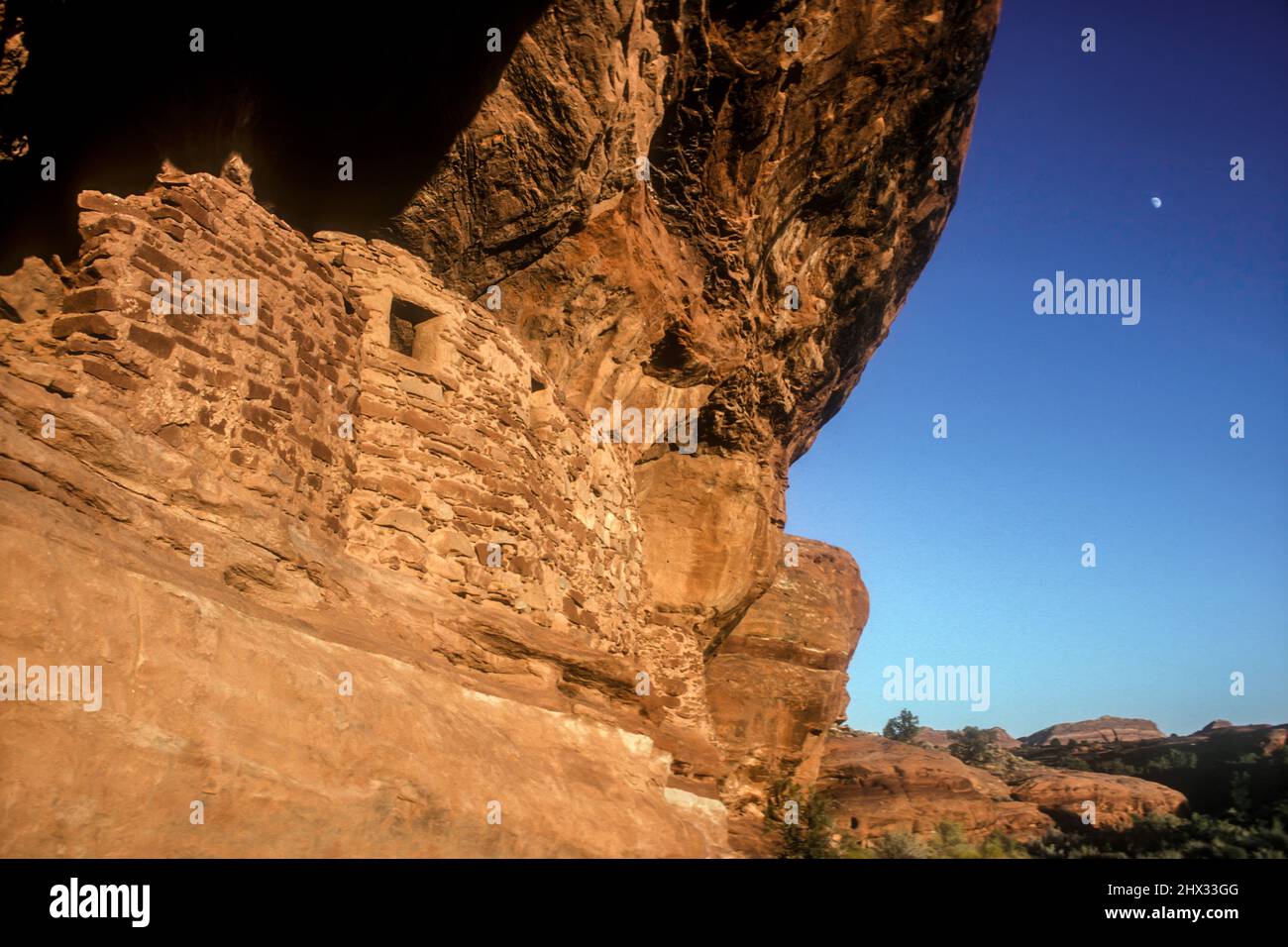 The moon at sunset over an ancient cliff dwelling in the Fish Creek Canyon Wilderness Study Area ...
