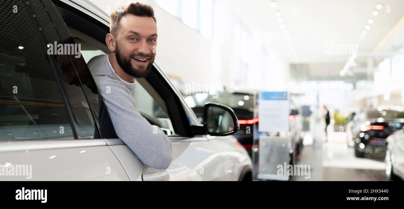 a satisfied customer purchases a new car at a dealership Stock Photo ...