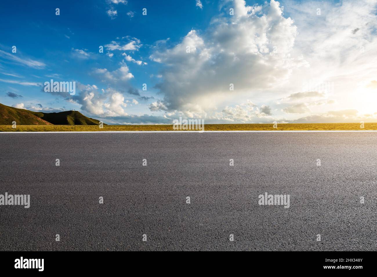 Empty asphalt road platform and beautiful blue sky with white clouds at ...