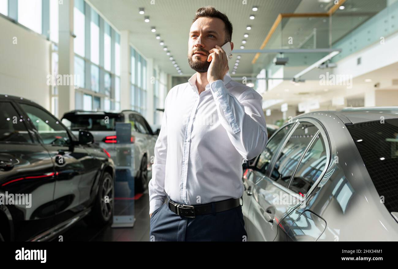 businessman chooses a new car in a premium car dealership Stock Photo ...