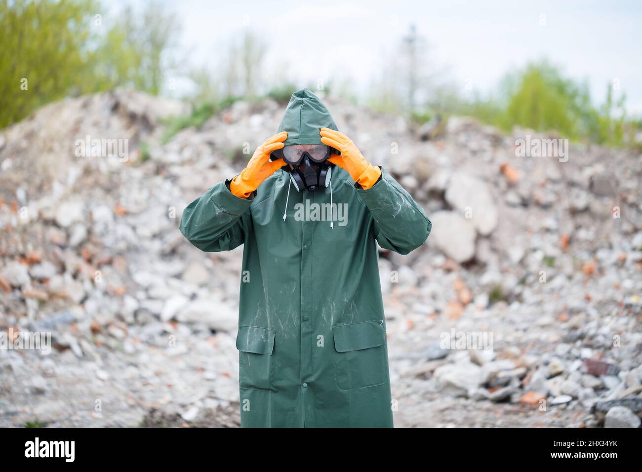 A man in a protective mask and protective clothing explores the danger ...