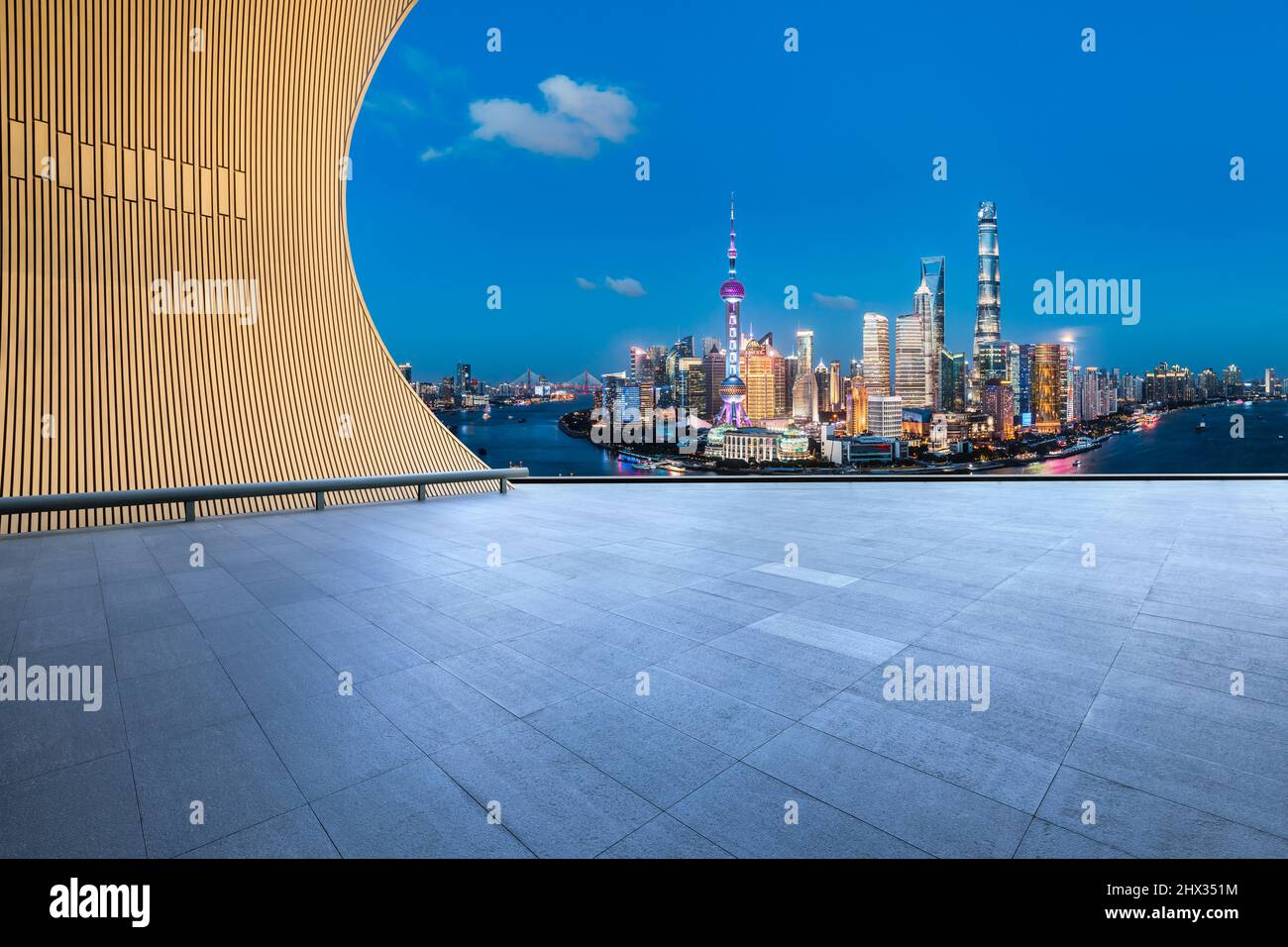 Empty square floor and city skyline with buildings in Shanghai at night ...