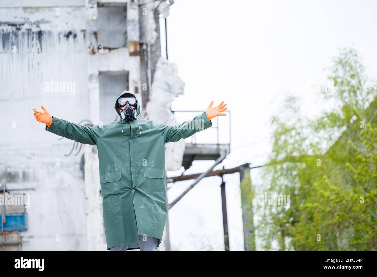 A man in a protective mask and protective clothing explores a dangerous ...
